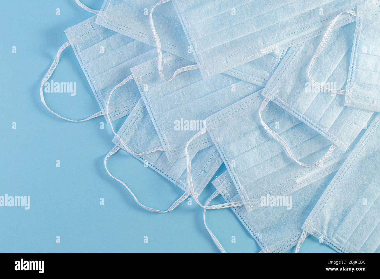 Prevent coronavirus. Medical protective mask on blue background. Face ...