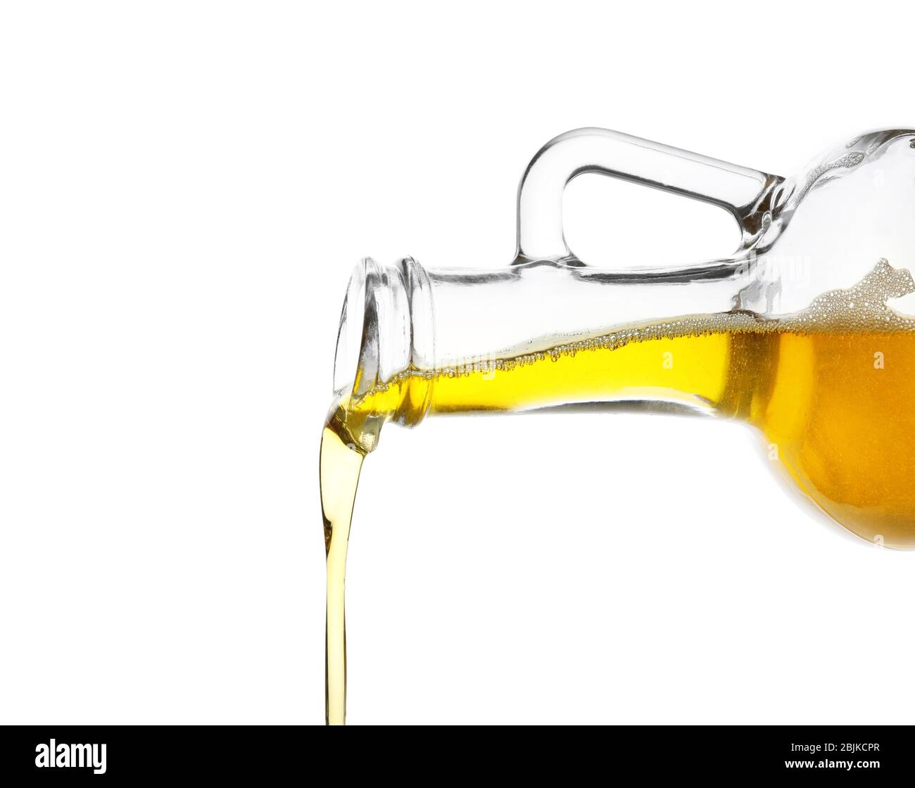Pouring cooking oil from pitcher, on white background Stock Photo - Alamy