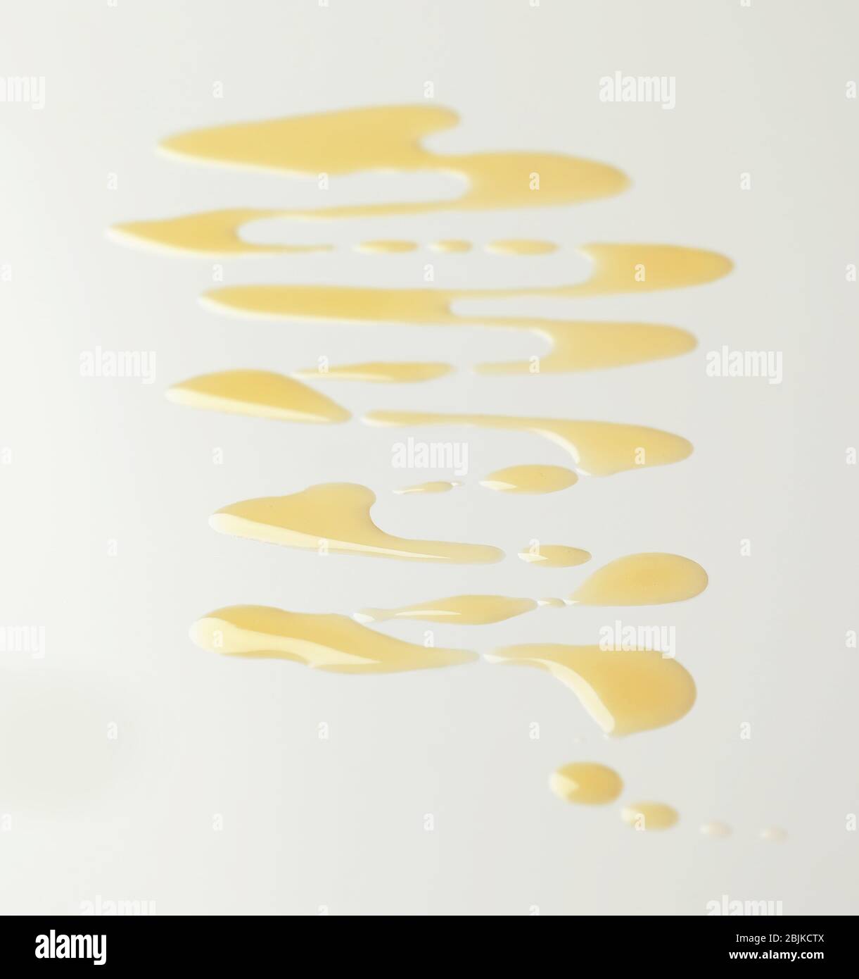 Spilled cooking oil on white background Stock Photo - Alamy