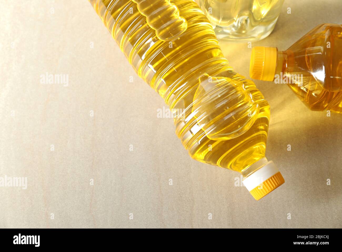 Bottles with cooking oil on light background Stock Photo - Alamy
