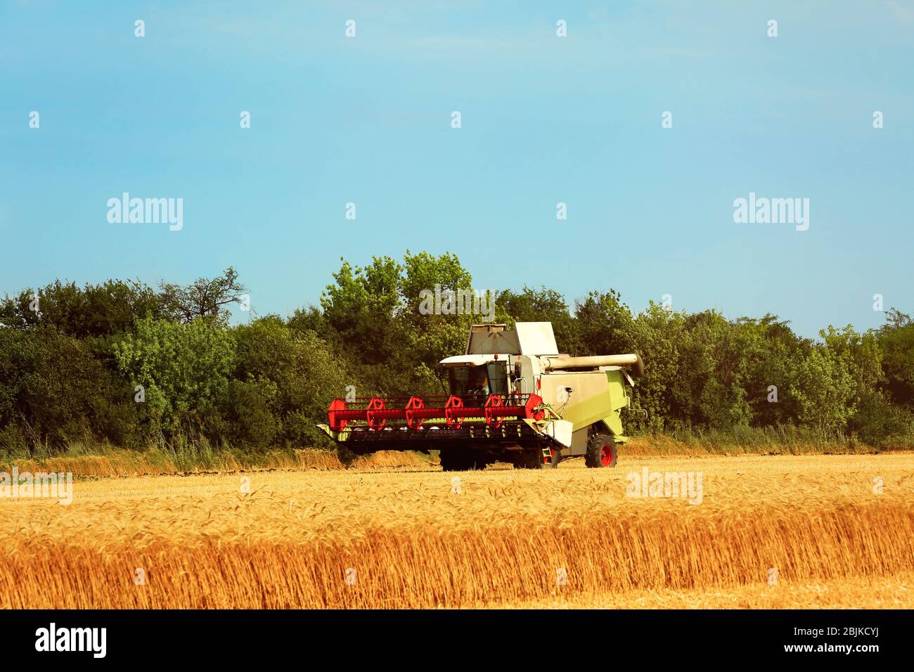 Combine harvester in field Stock Photo - Alamy