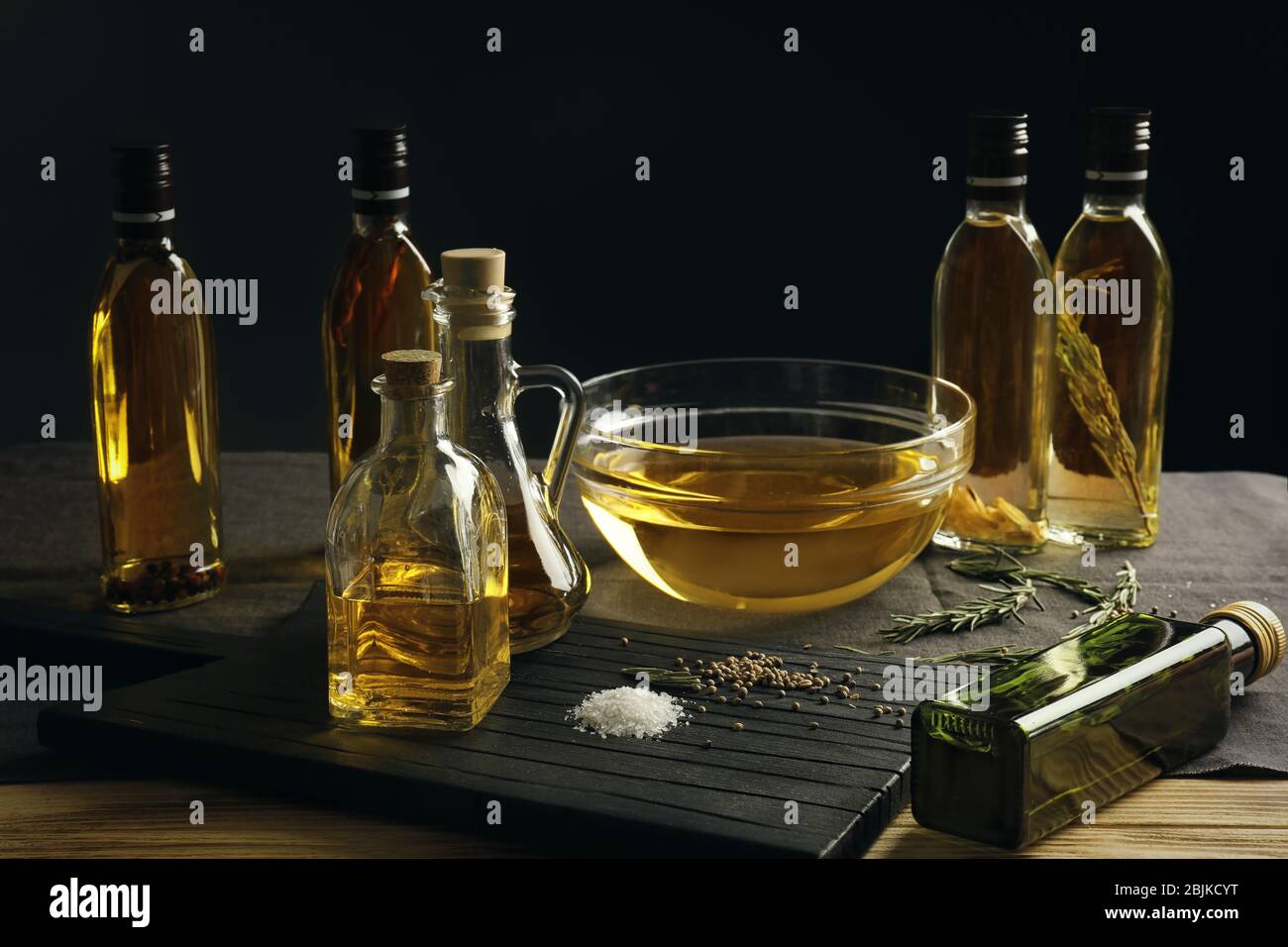 Composition with different cooking oils on table Stock Photo - Alamy