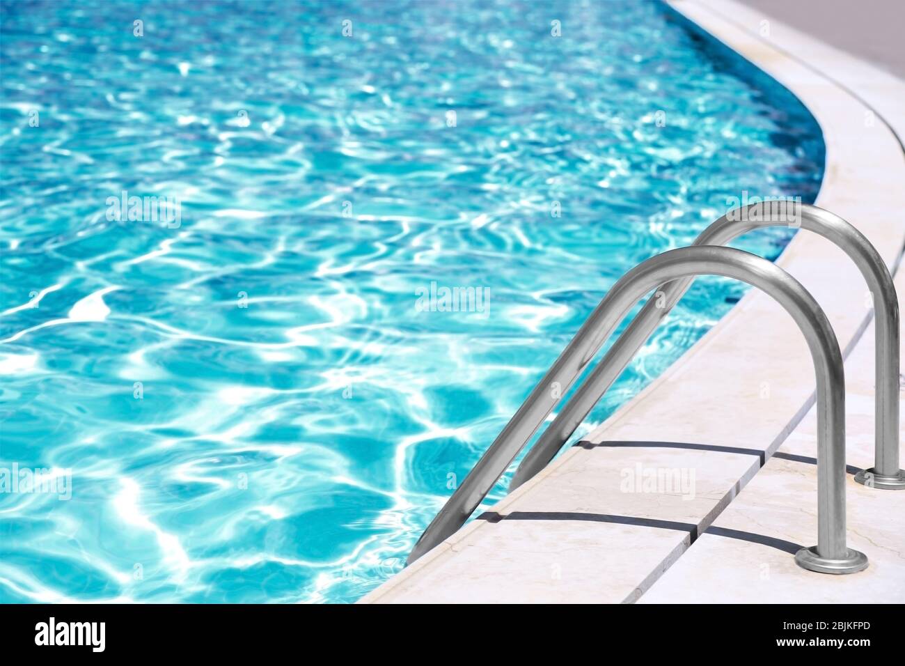 Modern swimming pool with stairs in luxury hotel Stock Photo - Alamy