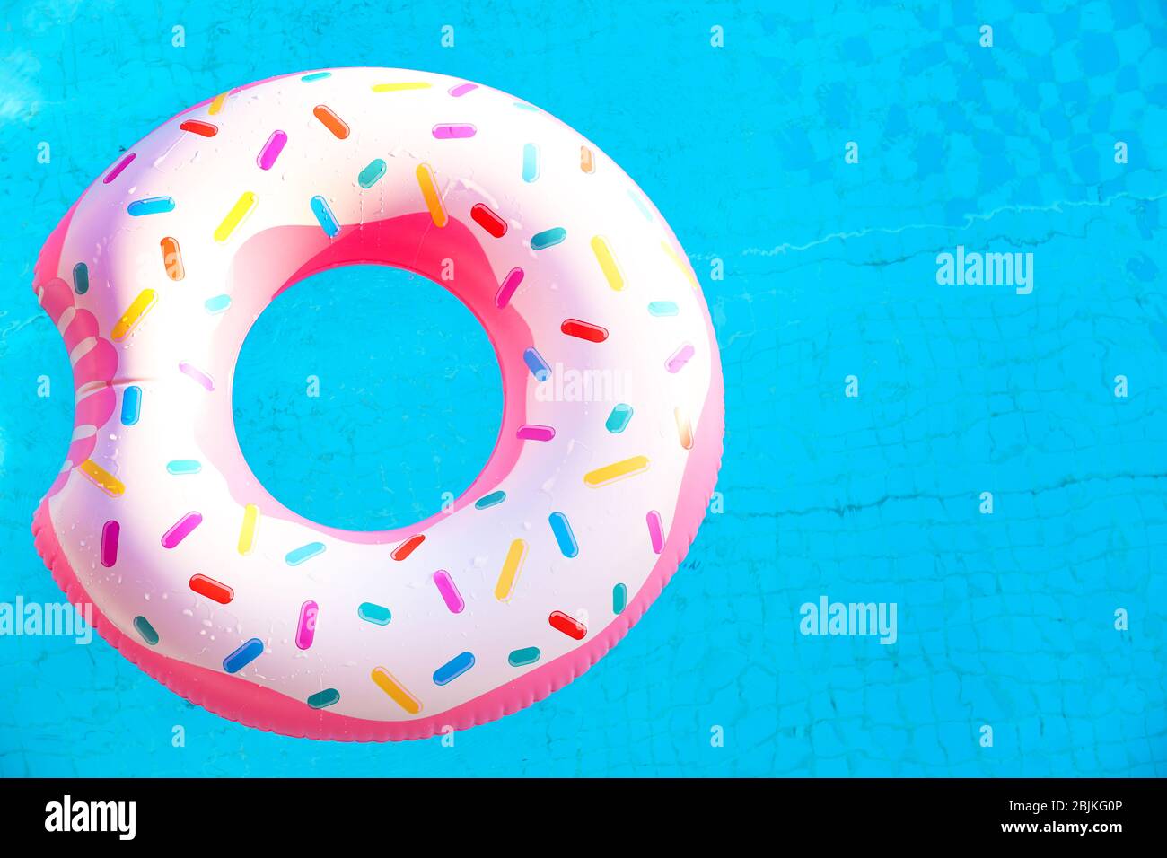 Inflatable rubber ring in shape of donut in pool Stock Photo - Alamy