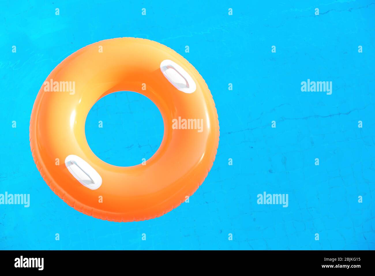 Colorful inflatable swim ring in pool Stock Photo - Alamy
