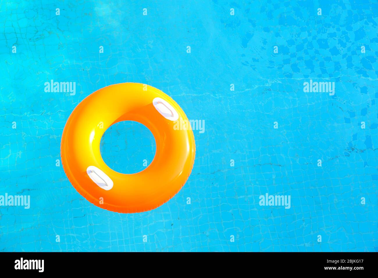 Colorful rubber ring floating in pool Stock Photo - Alamy