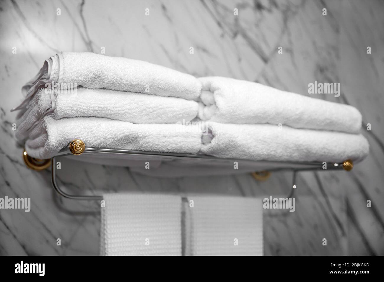 Stack of clean towels on shelf in bathroom Stock Photo - Alamy