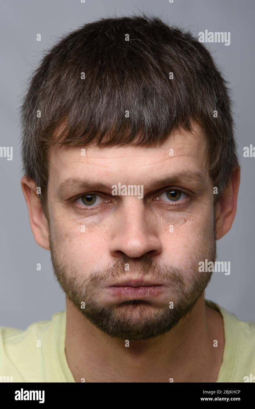 Closeup portrait of a resentful man of European appearance who pouted ...