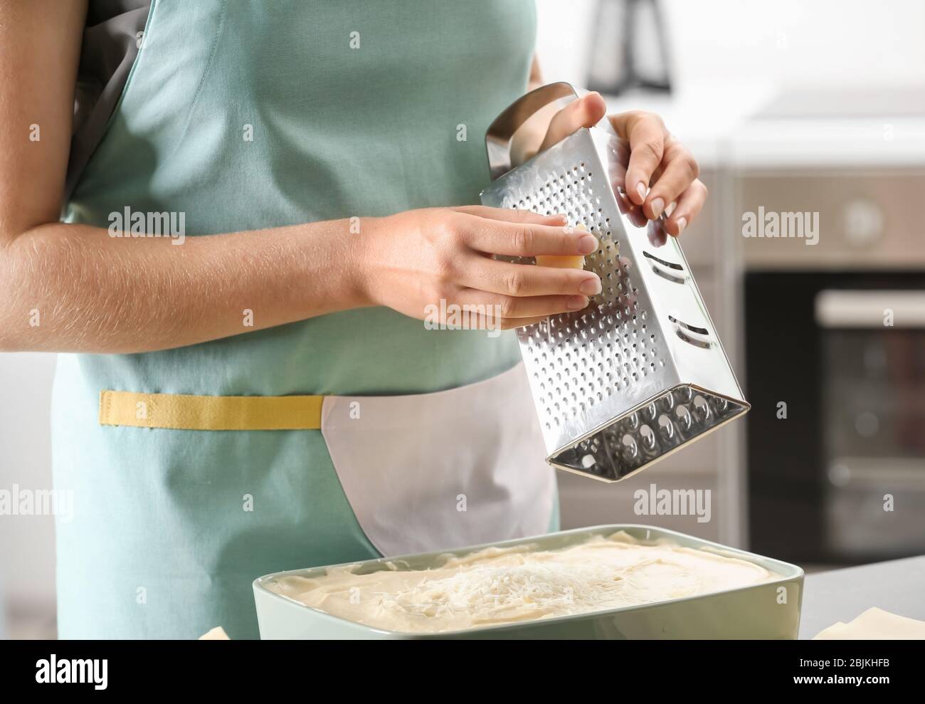 Woman grating cheese kitchen hi-res stock photography and images - Alamy