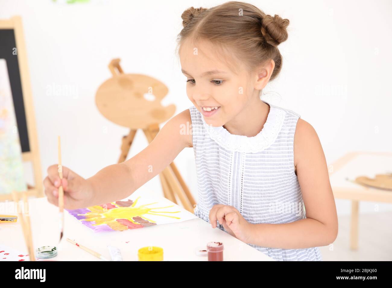 Little girl at painting lesson in classroom Stock Photo - Alamy