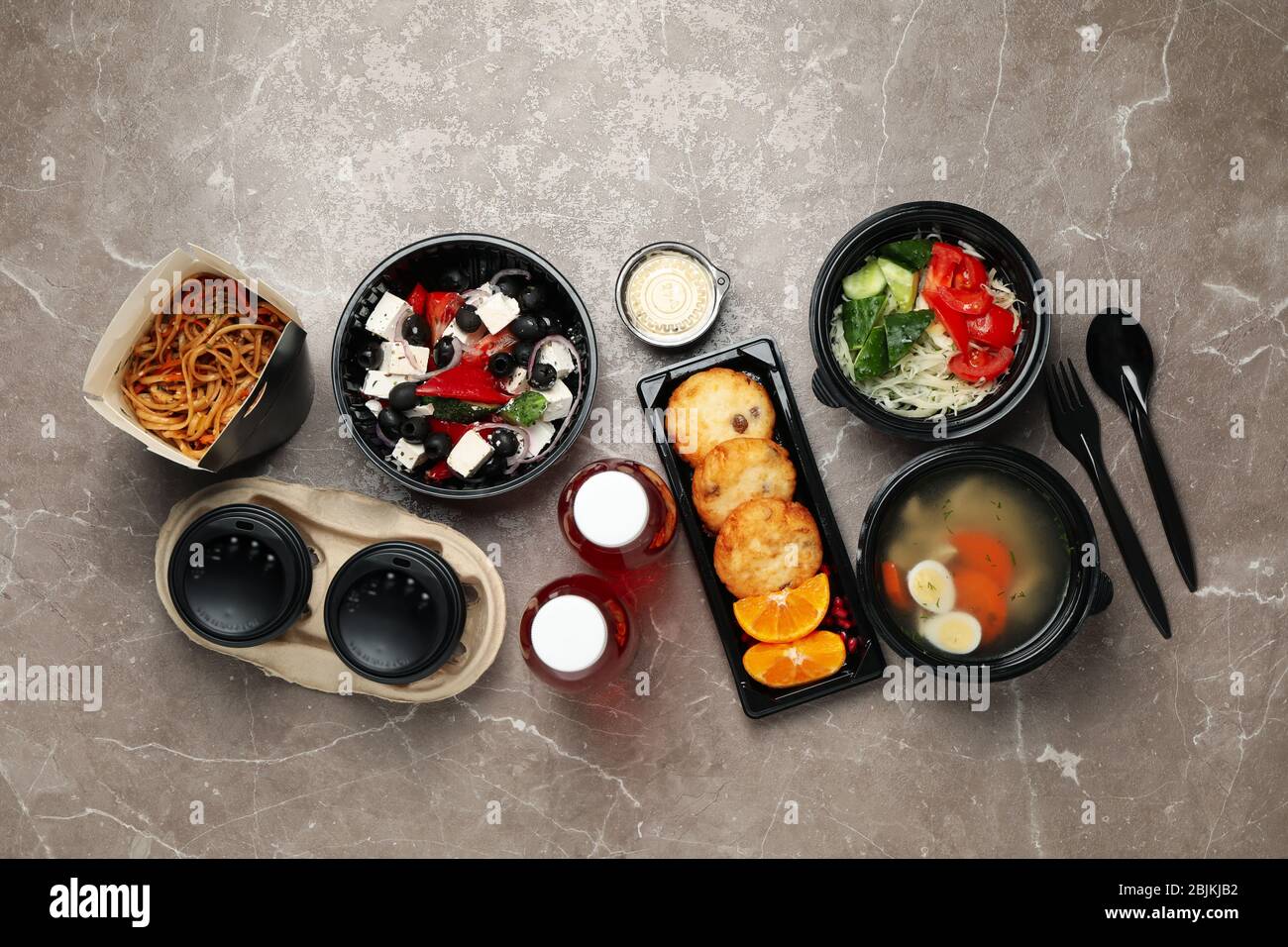 Flat lay with takeaway food on table. Food delivery Stock Photo - Alamy