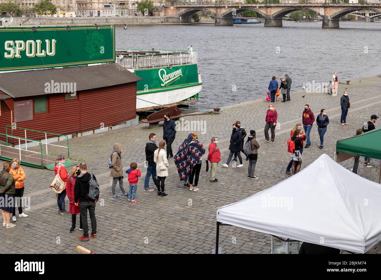 PRAGUE, CZECH REPUBLIC - APRIL 25, 2020: People standing in a queue at ...