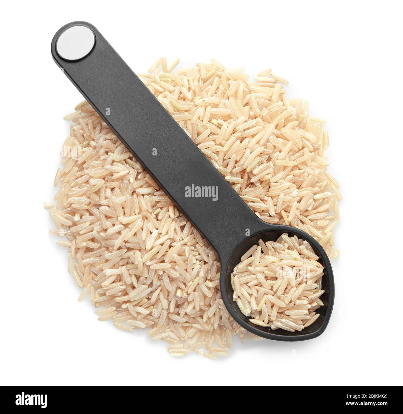 Measuring spoon and heap of brown rice on white background Stock Photo ...