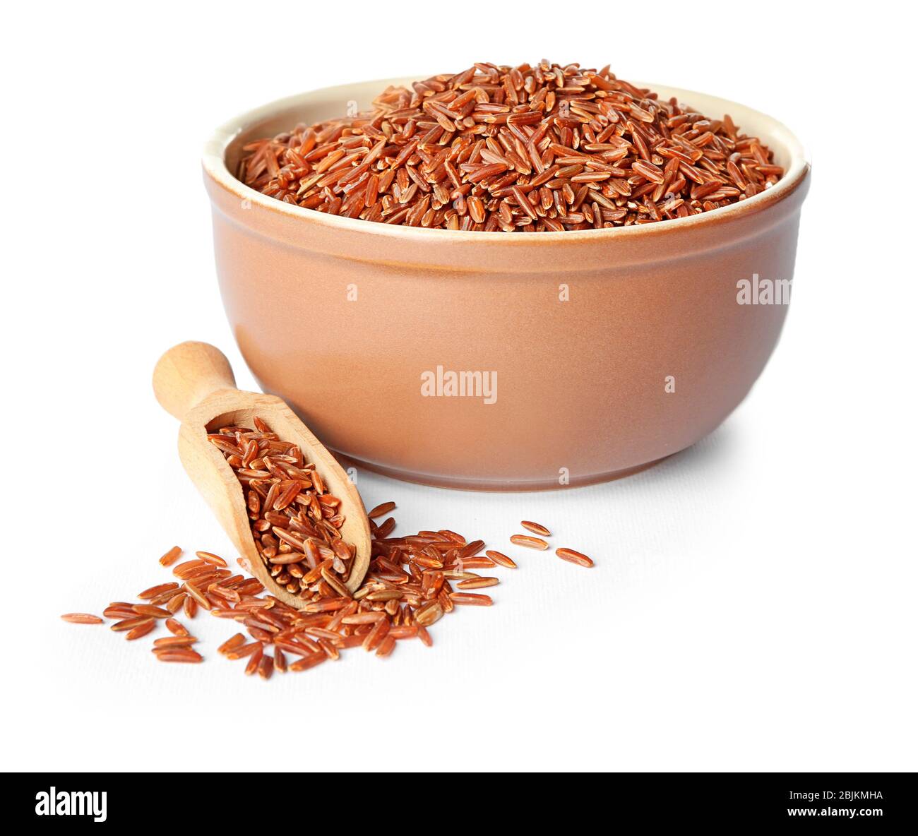Bowl and scoop with red Cargo rice on white background Stock Photo - Alamy