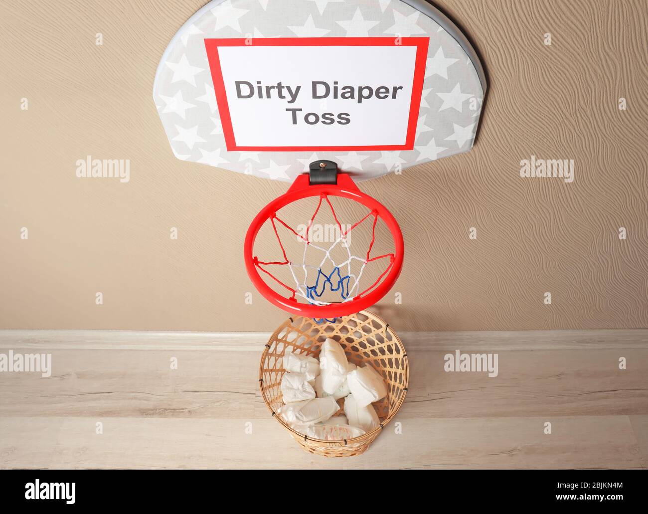 Basketball hoop and basket with diapers for game at baby shower party ...