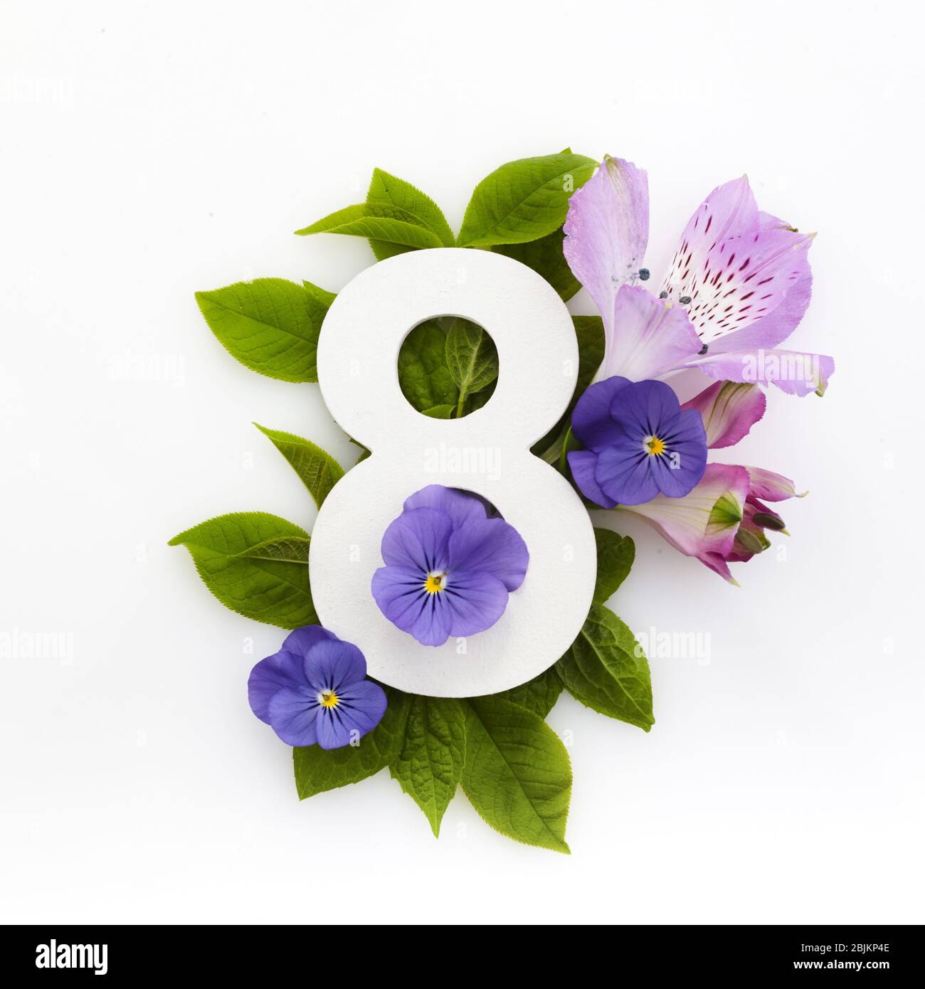 Creative layout with colourful flowers and number eight. Flat lay. Top ...