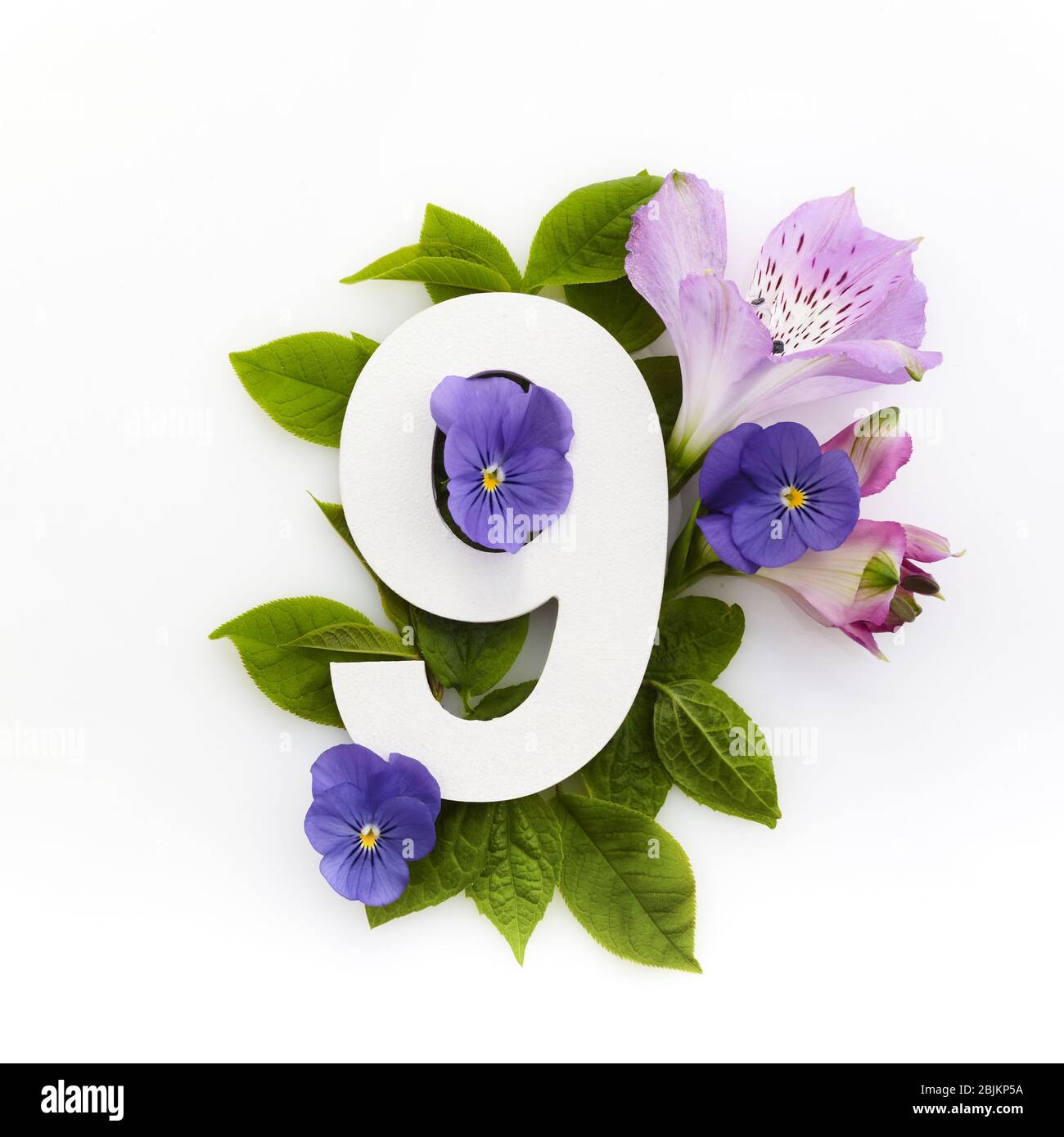 Creative layout with colourful flowers and number nine. Flat lay. Top ...