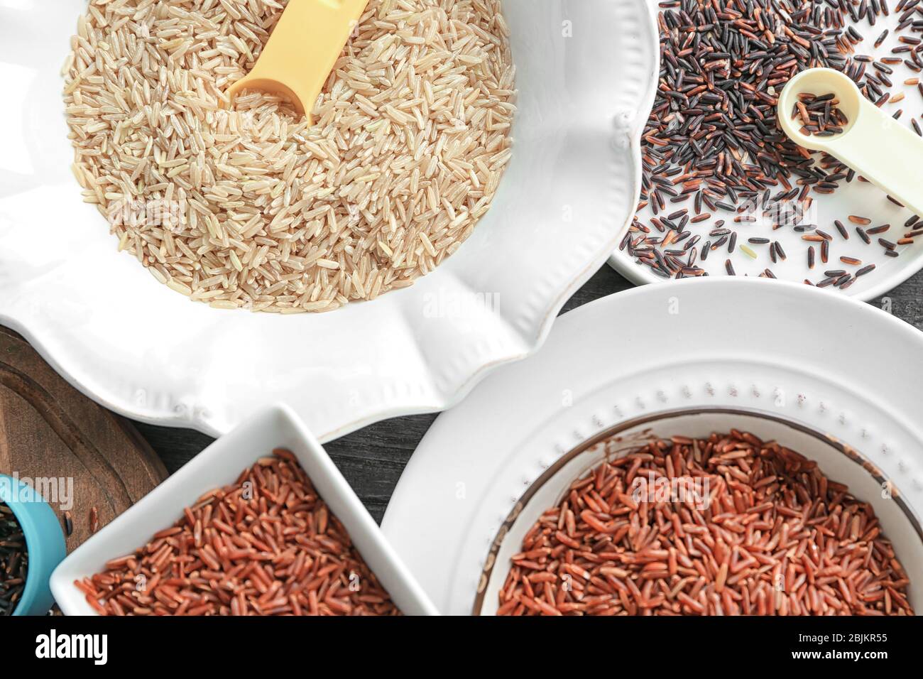 Different types of rice in bowls and plates on table Stock Photo - Alamy