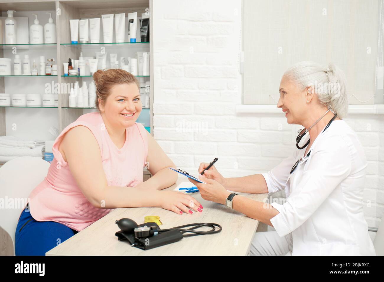 Overweight woman having consultation at doctor's office Stock Photo - Alamy