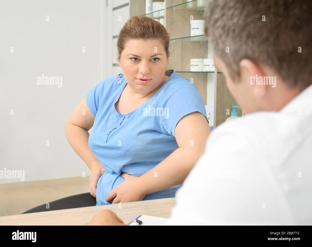 Overweight woman having consultation at doctor's office Stock Photo - Alamy