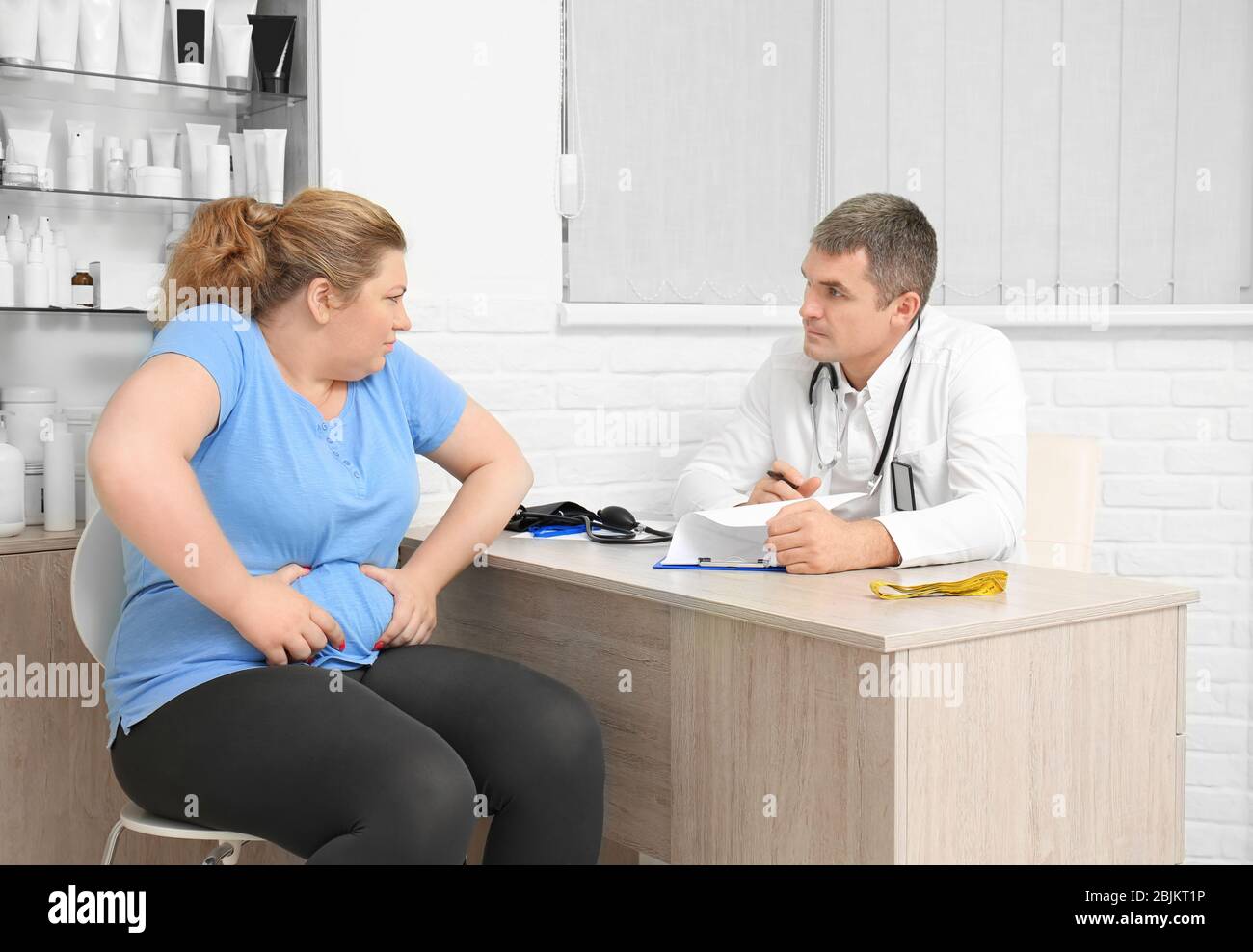 Overweight woman having consultation at doctor's office Stock Photo - Alamy