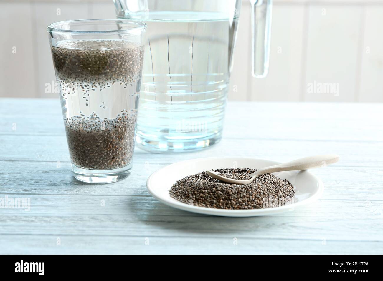 Composition with chia seeds and water on wooden table Stock Photo - Alamy