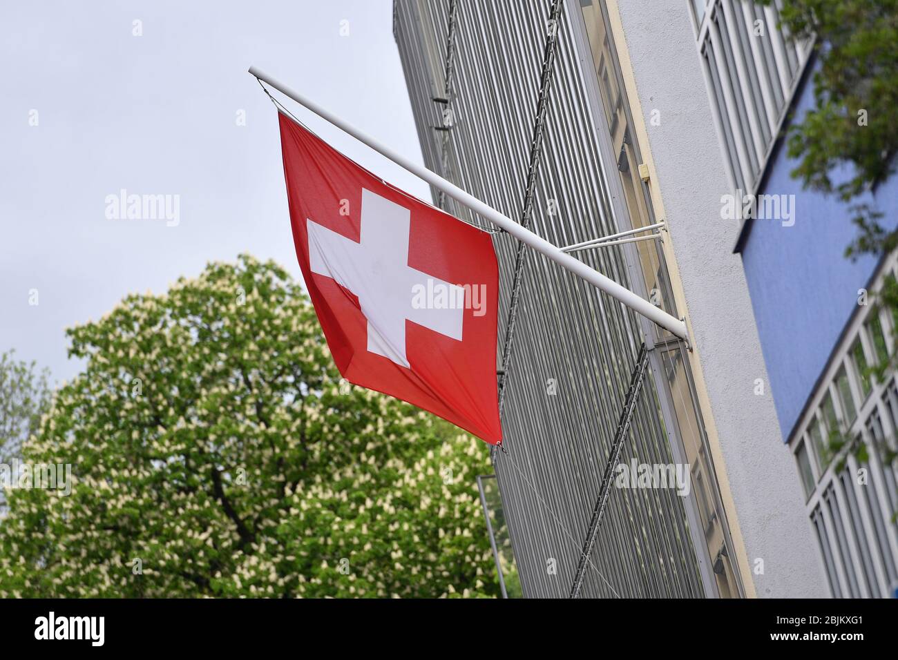 Munich, Deutschland. 29th Apr, 2020. Swiss flag hanging on a building ...