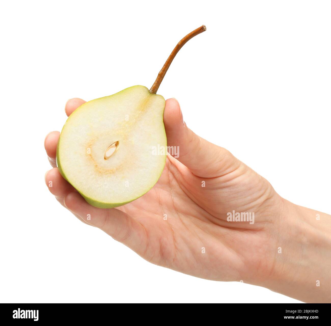 Hand of woman holding half of delicious ripe pear on white background ...