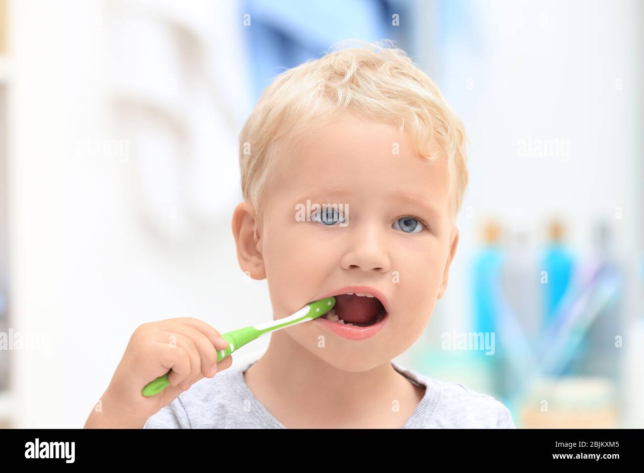 Cute little child cleaning teeth in bathroom Stock Photo - Alamy