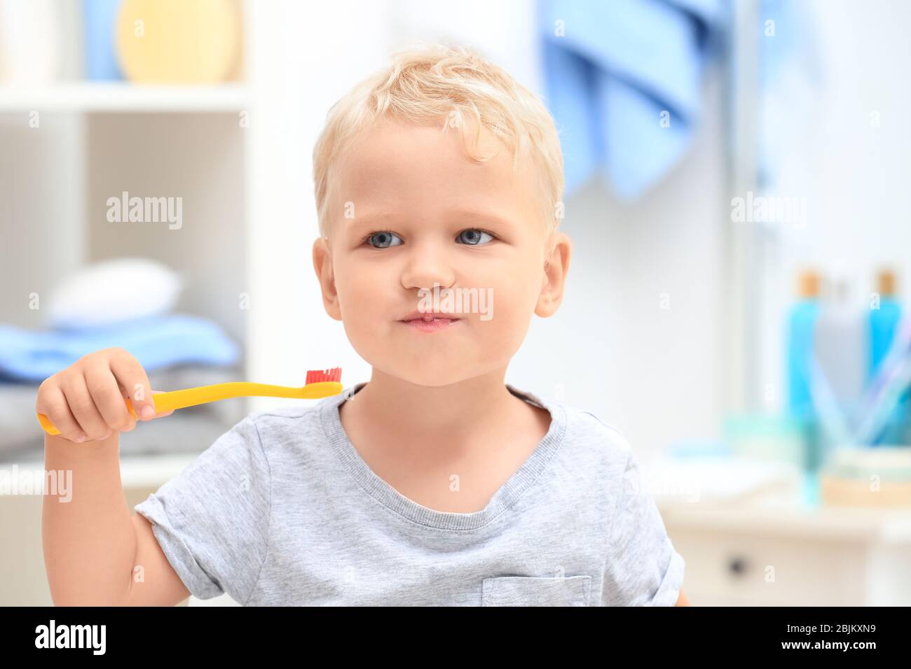 Cute little child cleaning teeth in bathroom Stock Photo - Alamy