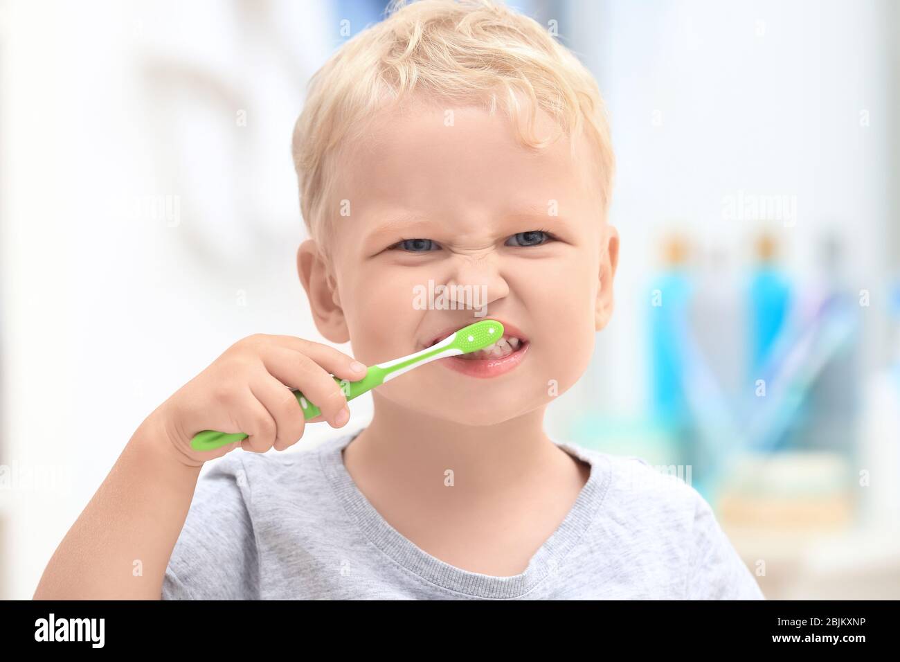 Cute little child cleaning teeth in bathroom Stock Photo - Alamy