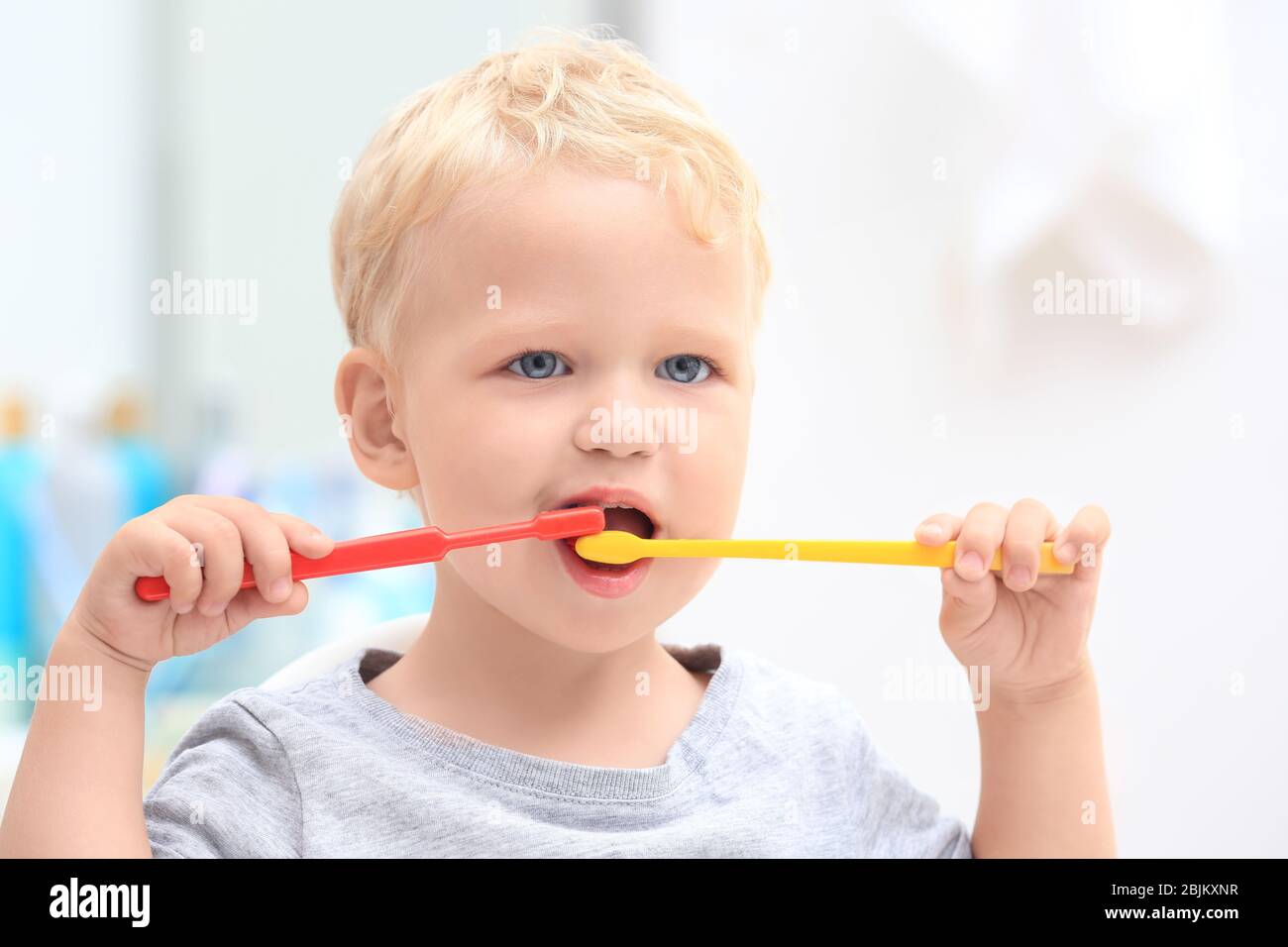 Cute little child cleaning teeth in bathroom Stock Photo - Alamy