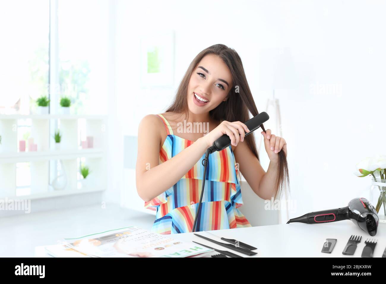 Young female blogger styling hair at home Stock Photo - Alamy