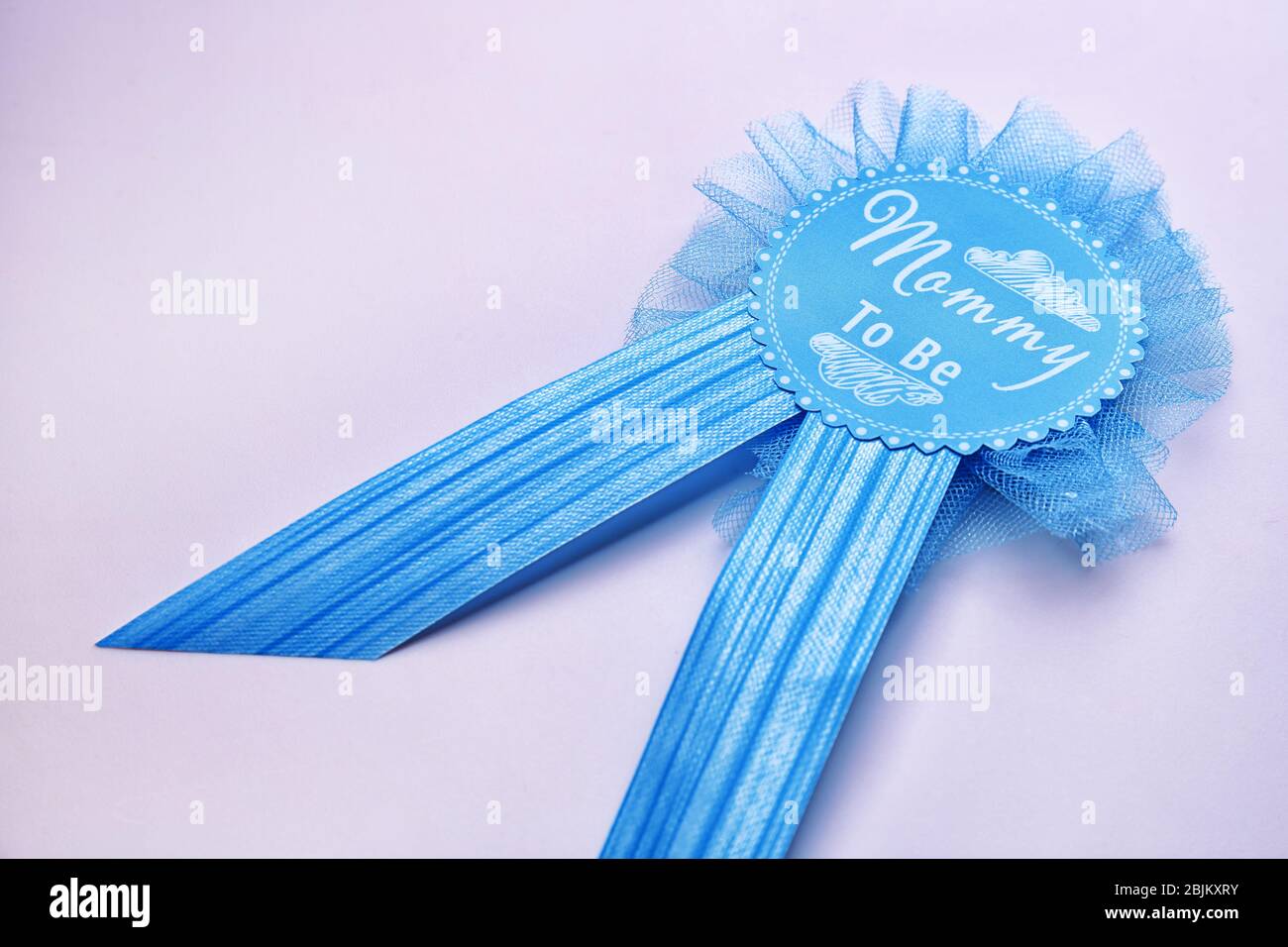 Beautiful award ribbon for baby shower party on color background Stock ...