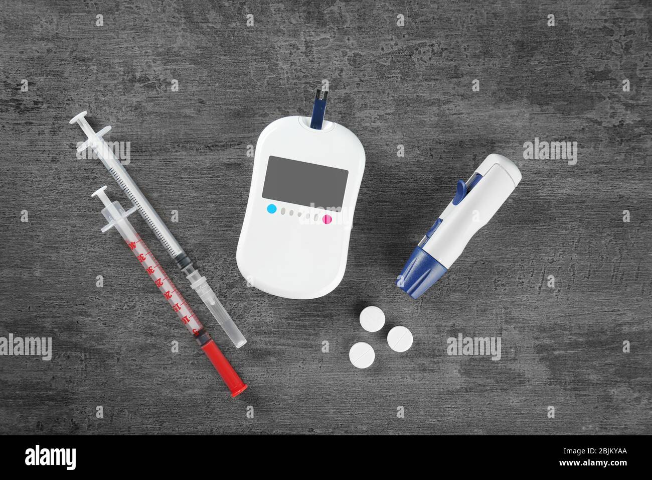 Composition with digital glucometer on grey background. Diabetes ...