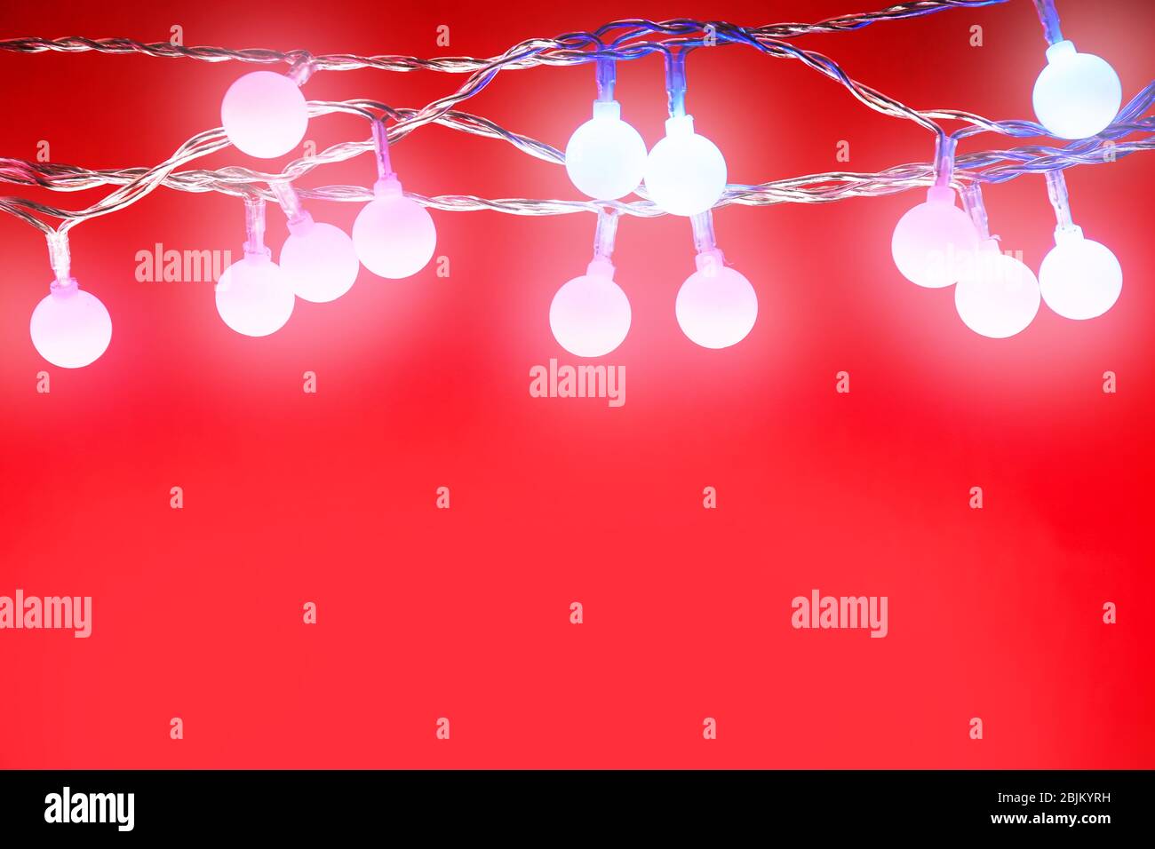 Christmas lights on color background Stock Photo - Alamy