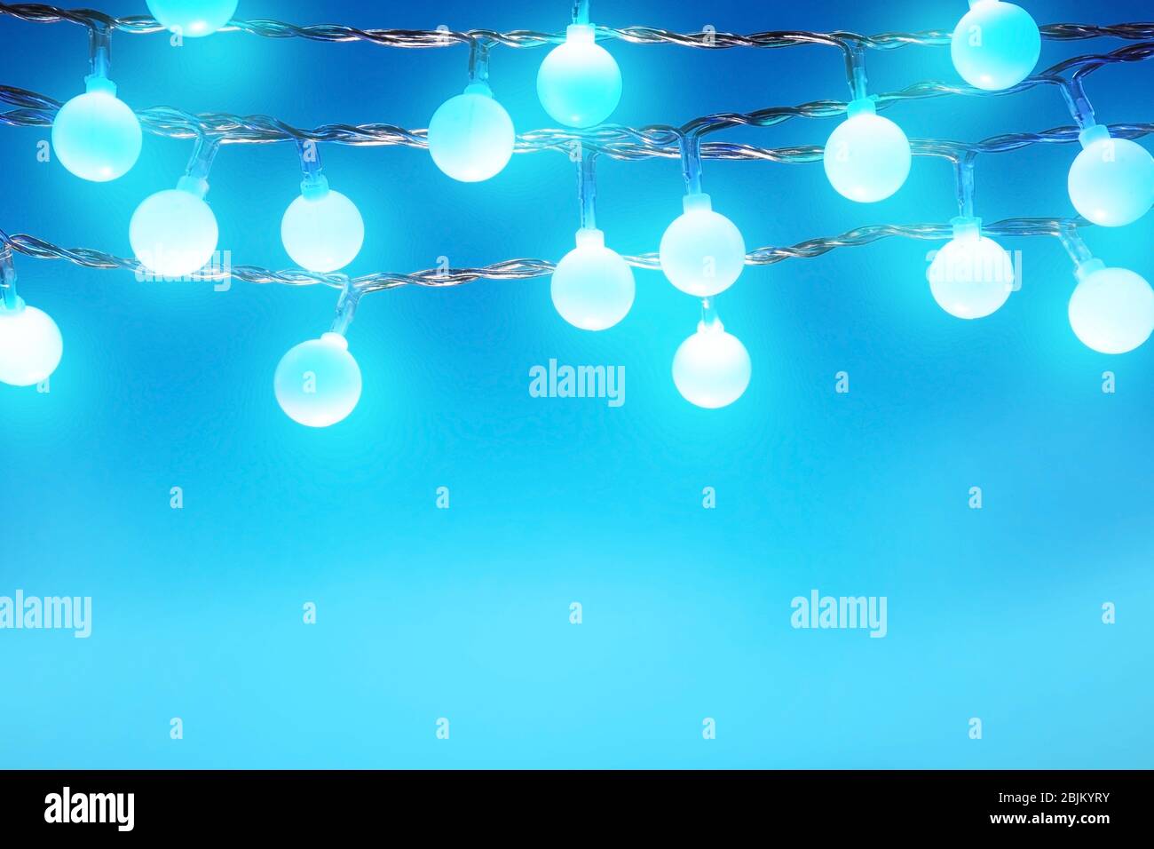 Christmas lights on color background Stock Photo - Alamy