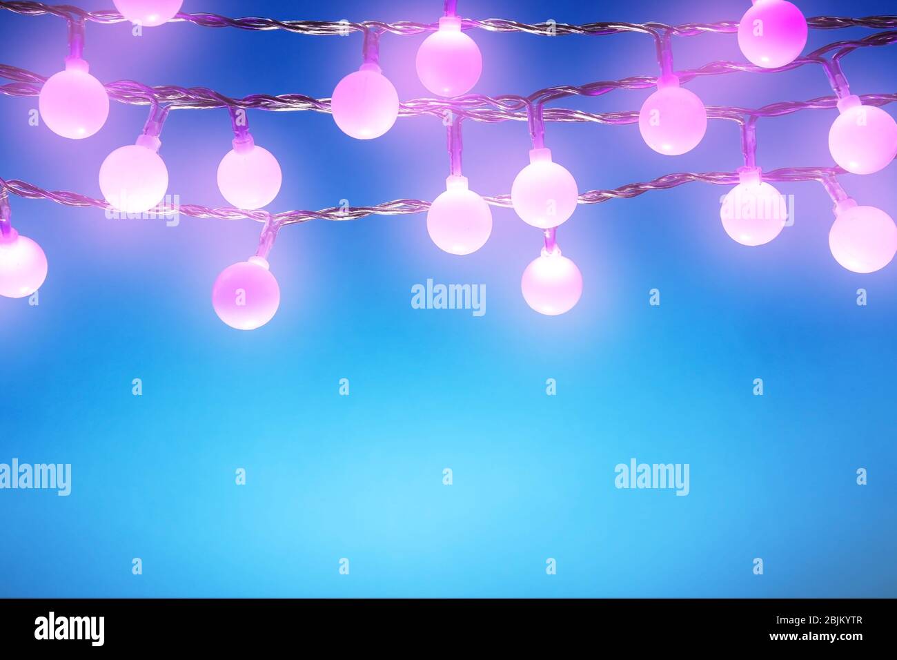 Christmas lights on color background Stock Photo - Alamy