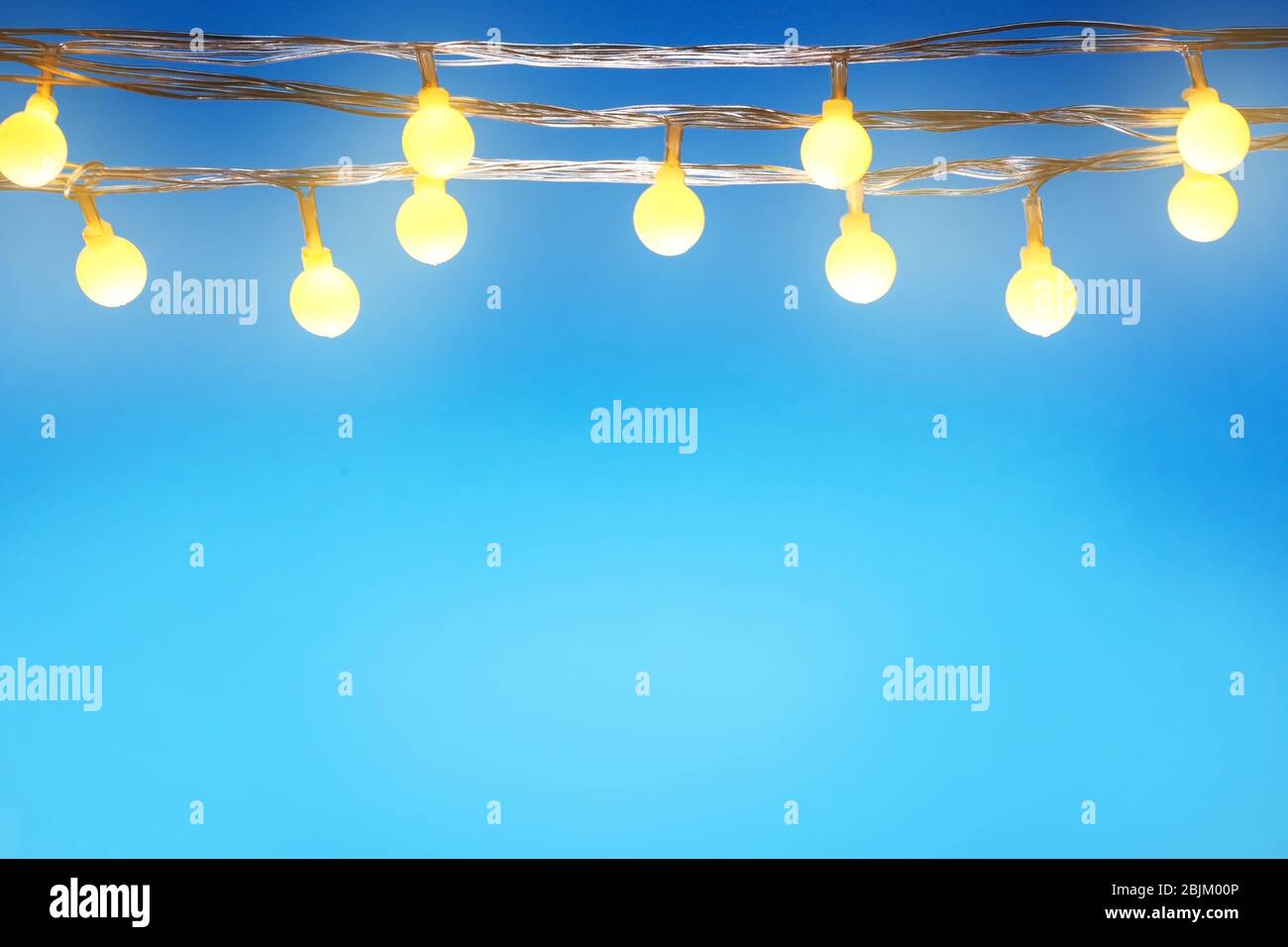Christmas lights on color background Stock Photo - Alamy
