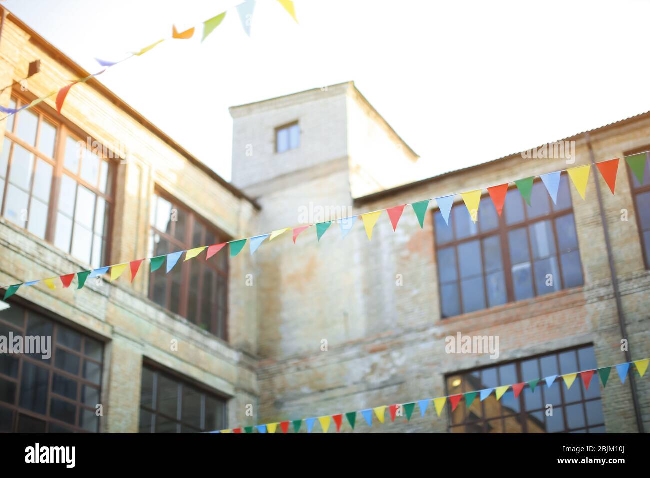 Ribbon garland as decor near building outdoors Stock Photo - Alamy