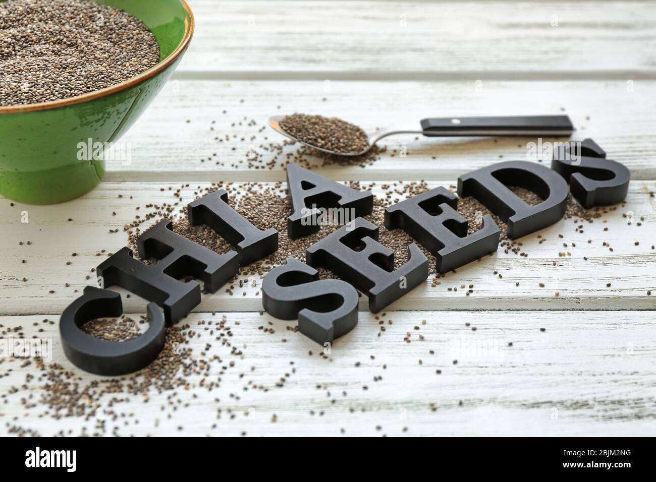 Composition with chia seeds and letters on table Stock Photo - Alamy