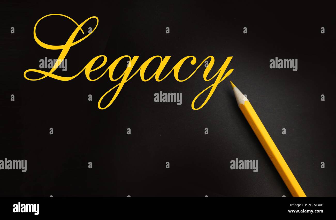Legacy Word, written with yellow crayon pencil on black paper ...