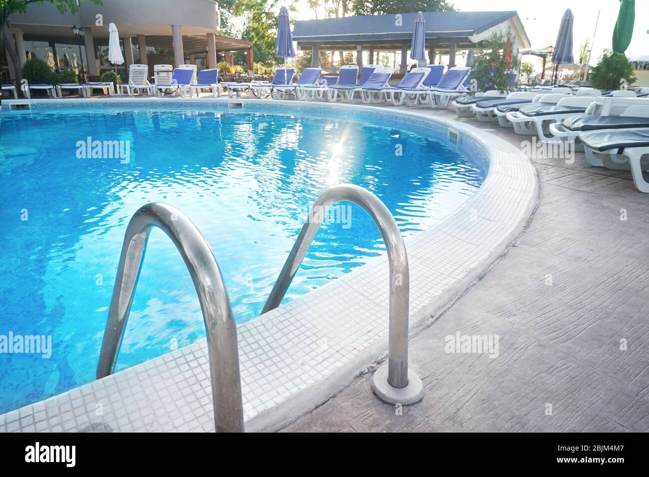 Modern swimming pool with ladder outdoors Stock Photo - Alamy