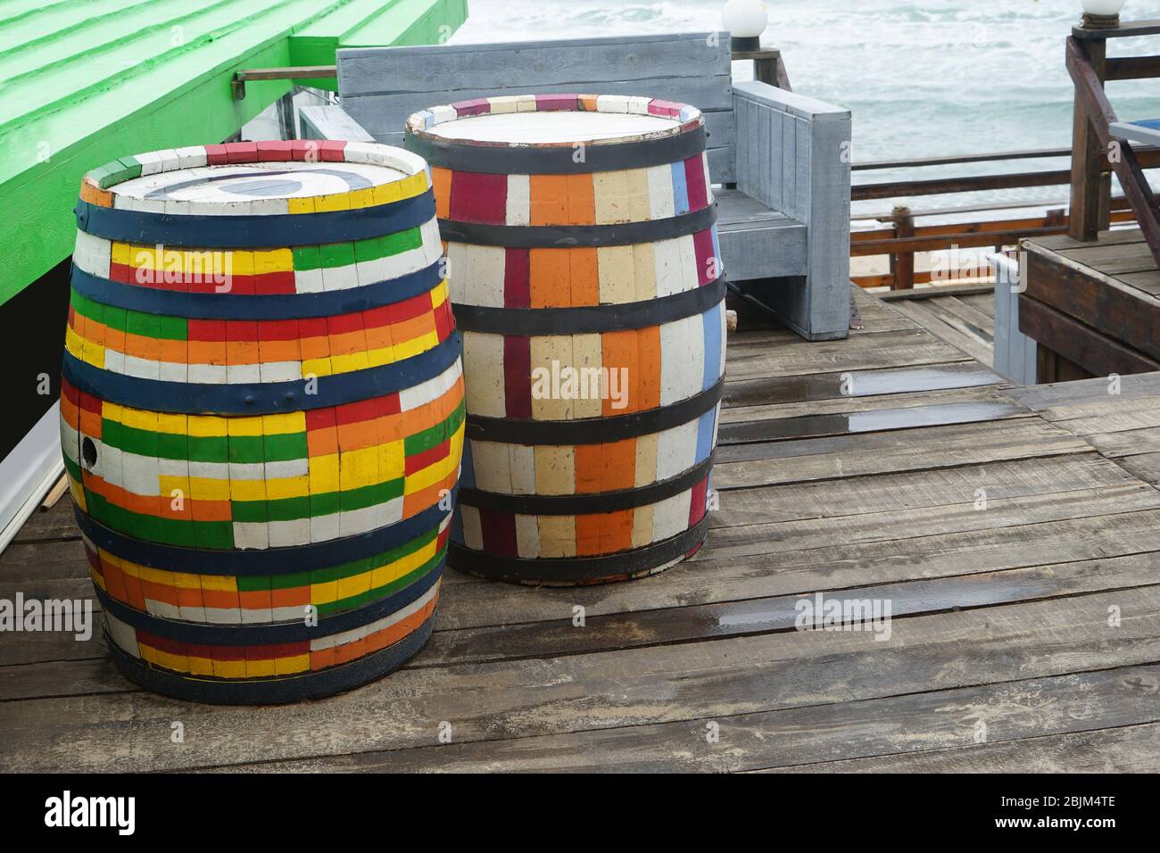 Colorful painted barrels on deck of boat. Recycling concept Stock Photo ...