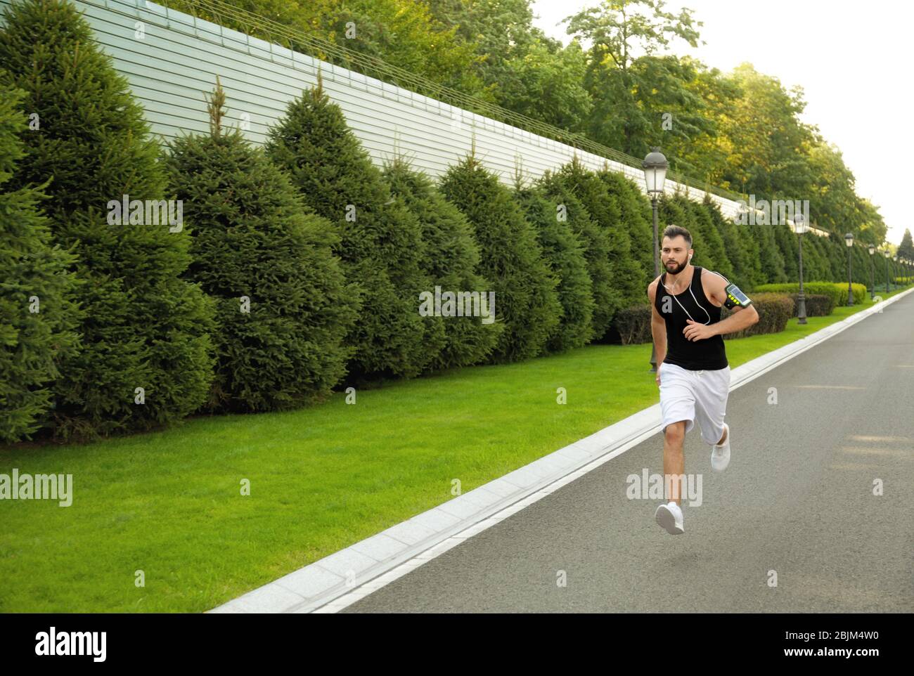 Sporty man running outdoors Stock Photo - Alamy