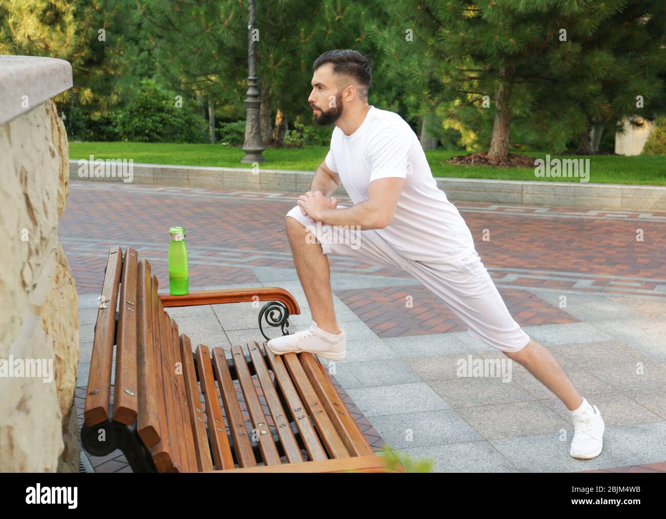 Man stretching in park hi-res stock photography and images - Alamy