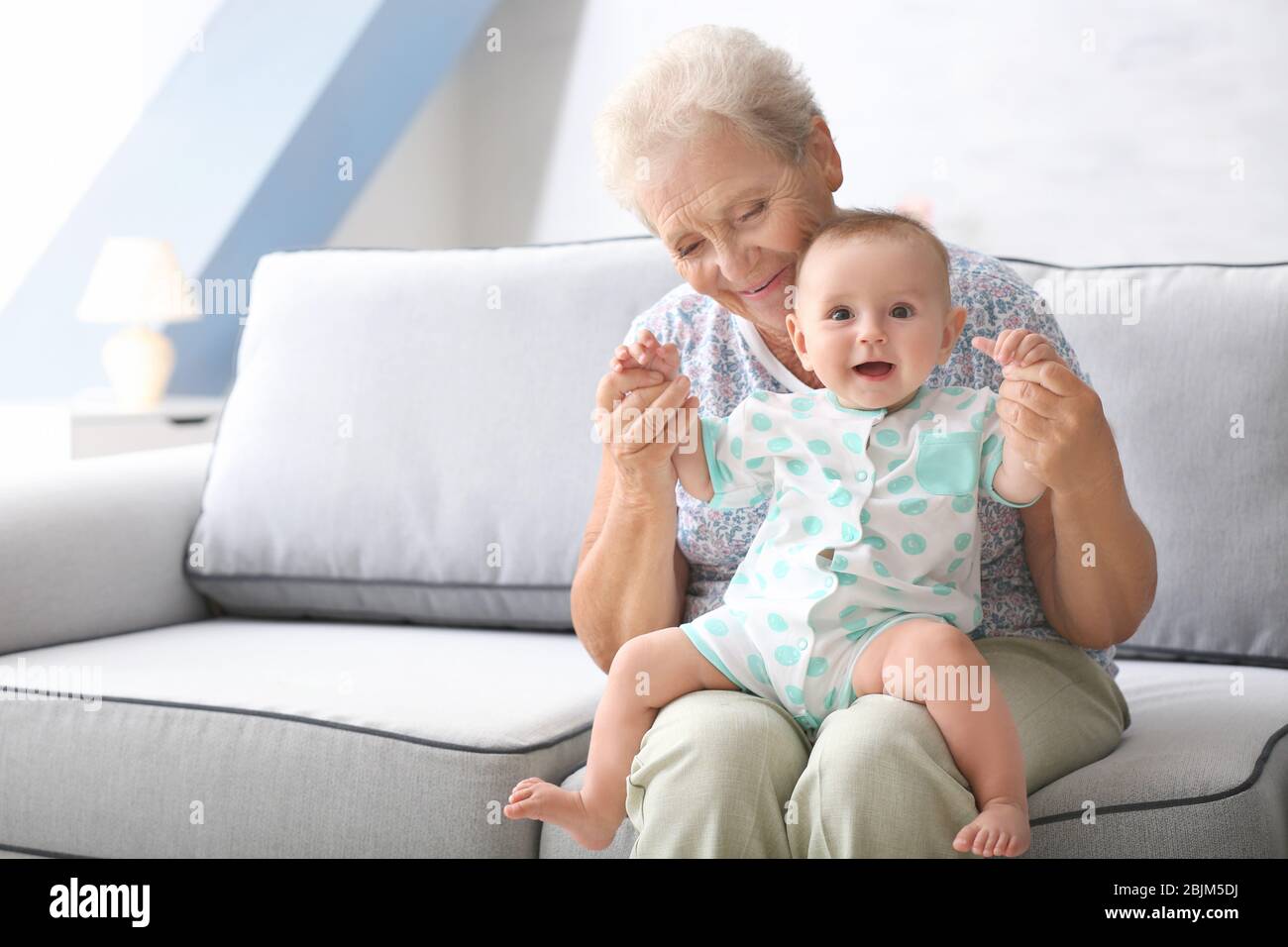 Senior woman playing with her little grandchild at home Stock Photo - Alamy