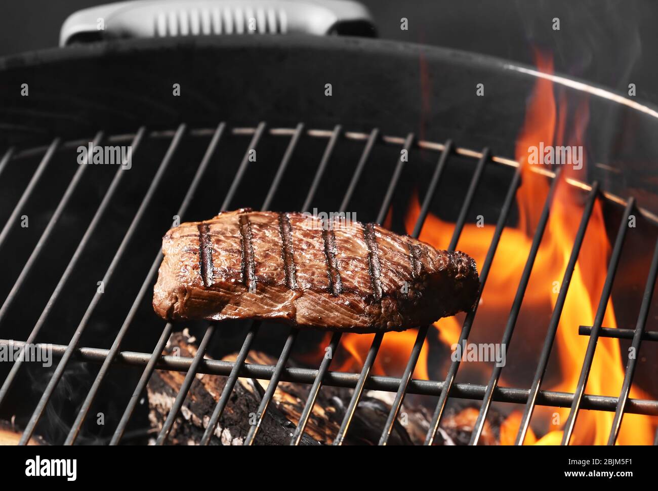 Delicious cooked meat on grill Stock Photo - Alamy