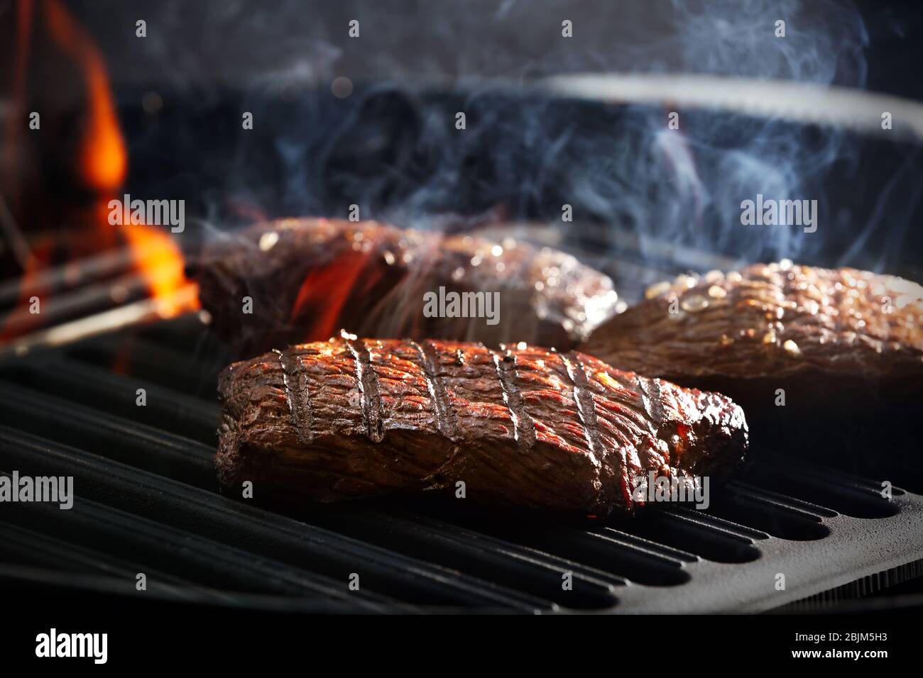 Delicious cooked meat on grill Stock Photo - Alamy
