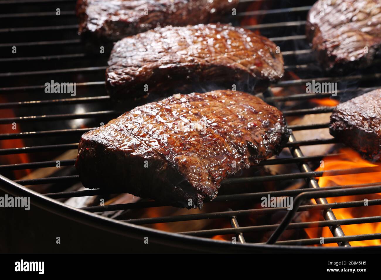 Delicious cooked meat on grill Stock Photo - Alamy